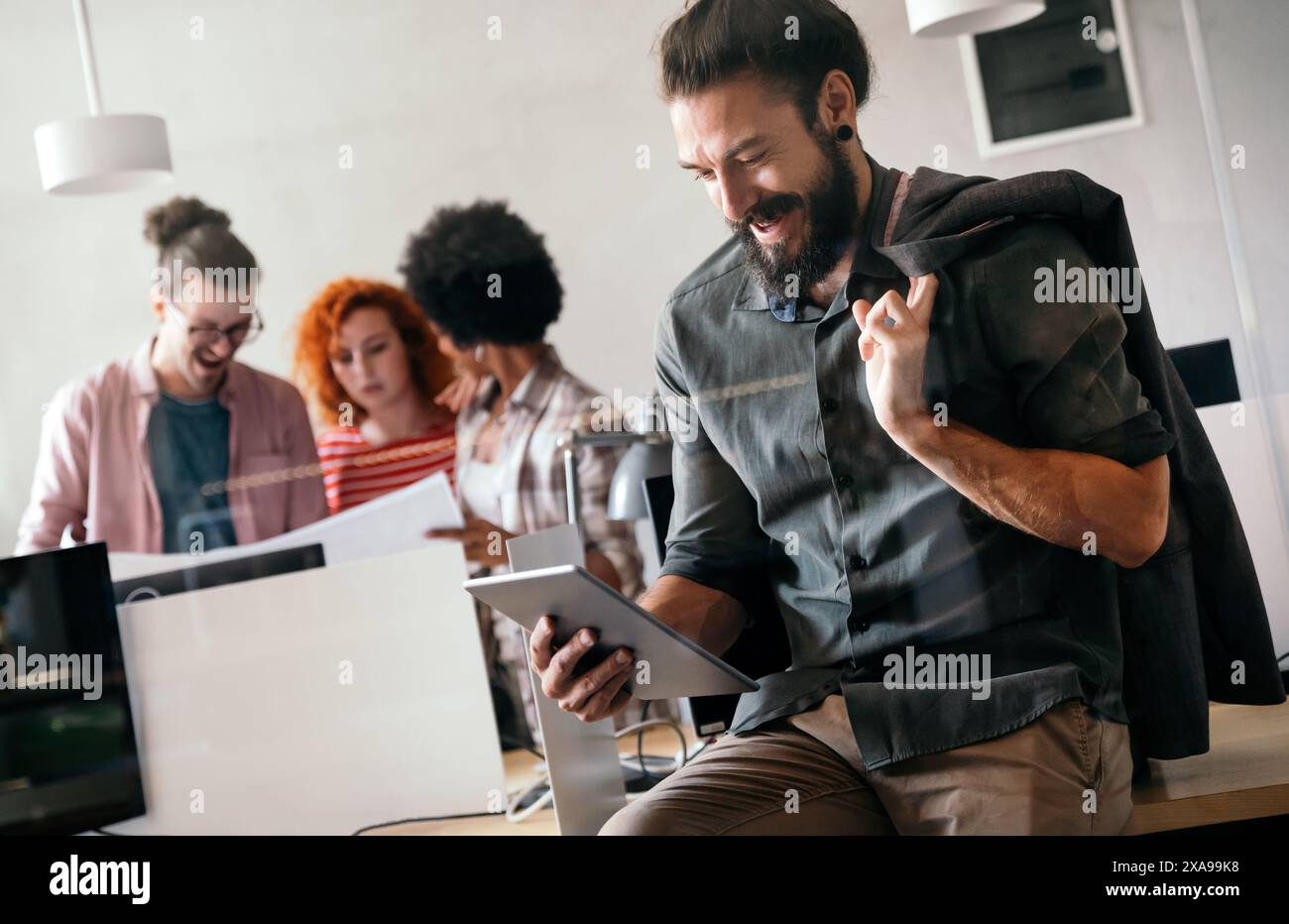 Portrait of happy success man working in a busy modern workplace ...