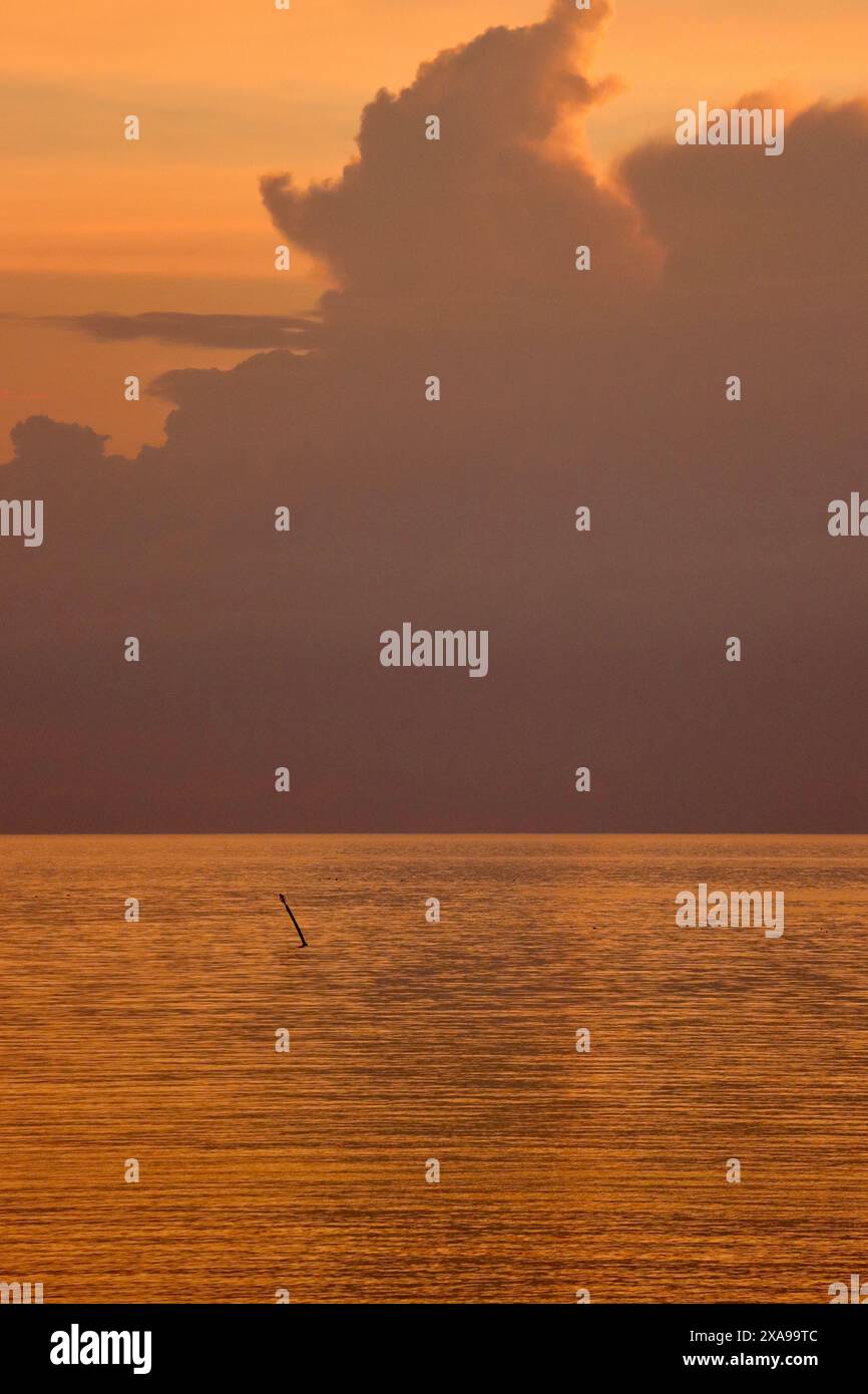 Cloud formations over the horizon after sunset over open sea on the ...