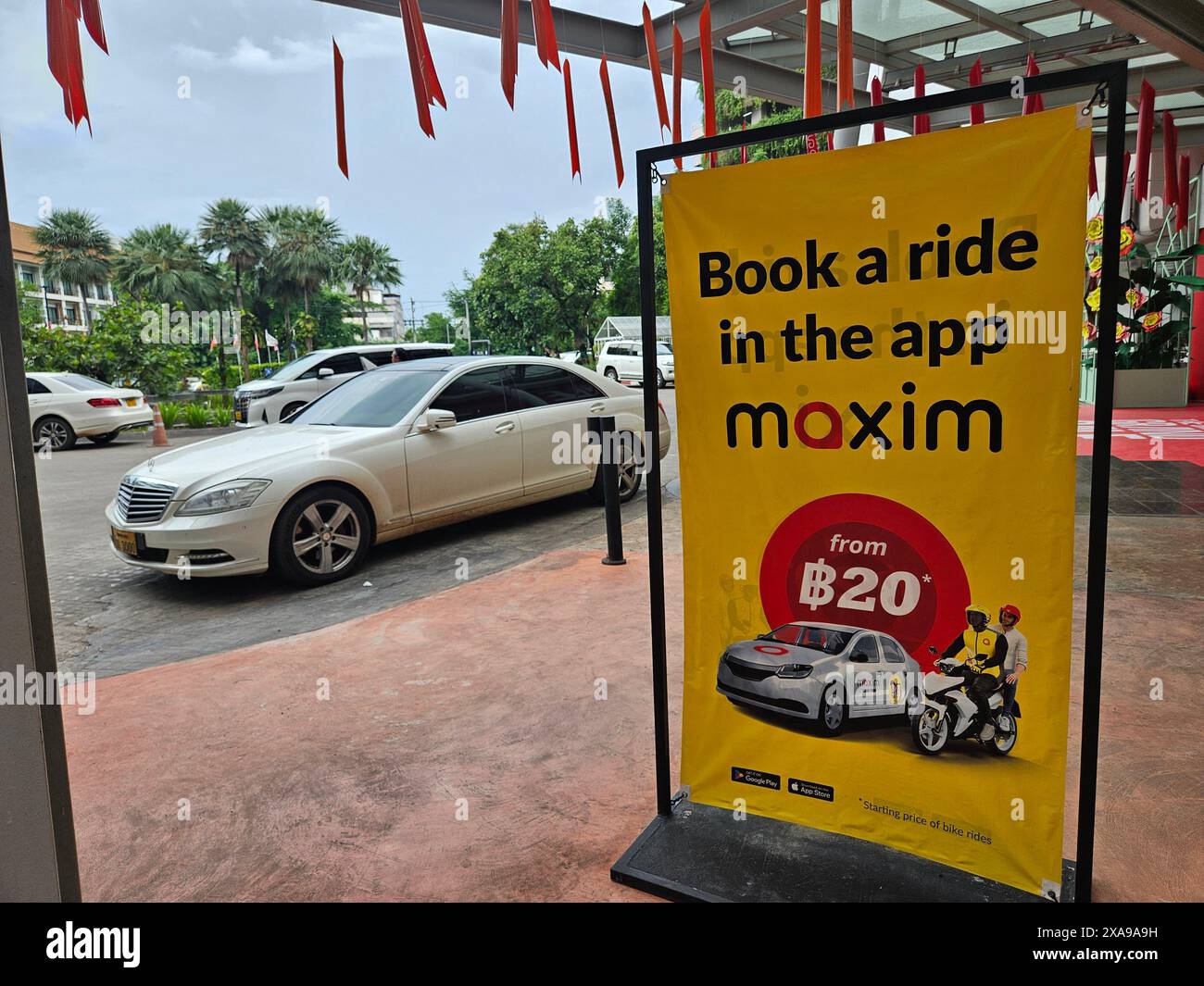 Udon Thani, Thailand - 05-06-2024: Maxim taxi app advertised outdoors ...