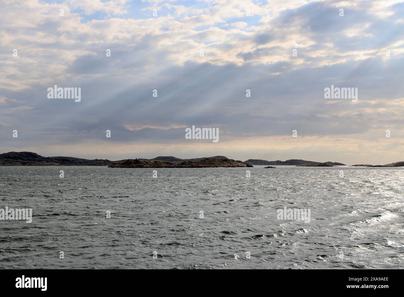 Sun light through clouds over outer Islands in Fjällbacka archipelago ...