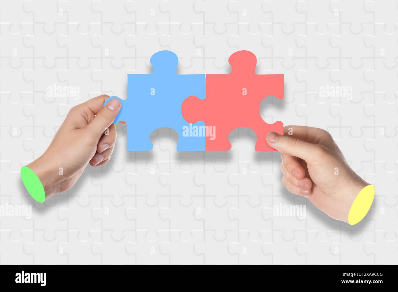 Hands putting pieces of jigsaw puzzle together on white background ...