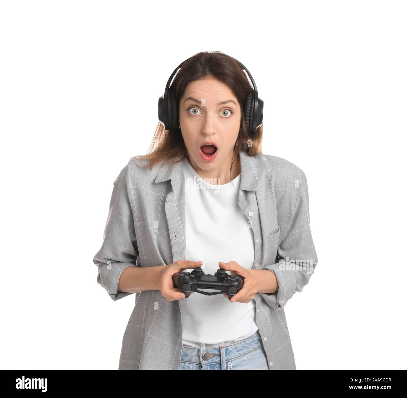 Surprised woman in headphones playing video game with controller on ...