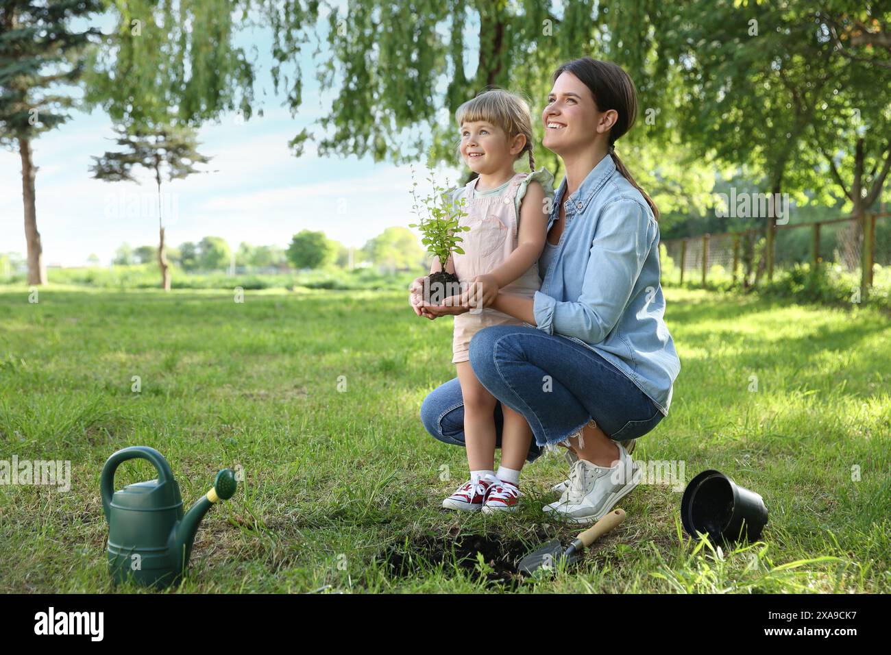 Happy caucasian daughter planting tree hi-res stock photography and ...