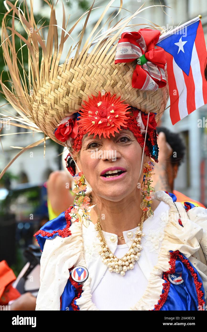 A woman dressed in costume attends the flag-raising ceremony for Puerto ...