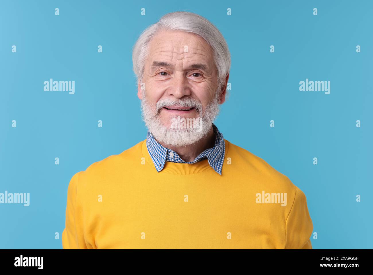 Portrait of stylish grandpa on light blue background Stock Photo - Alamy