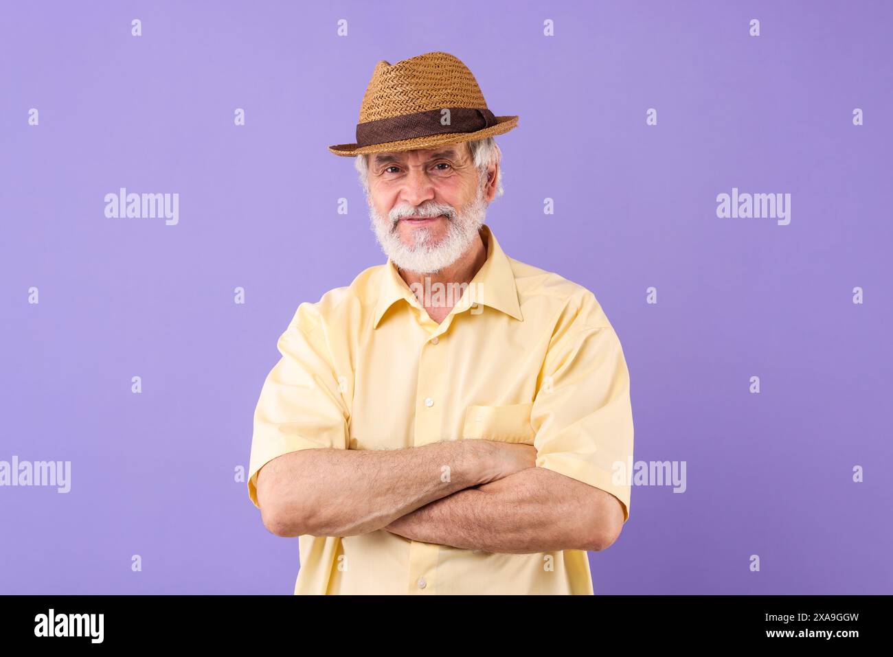 Portrait of stylish grandpa with hat on purple background Stock Photo ...