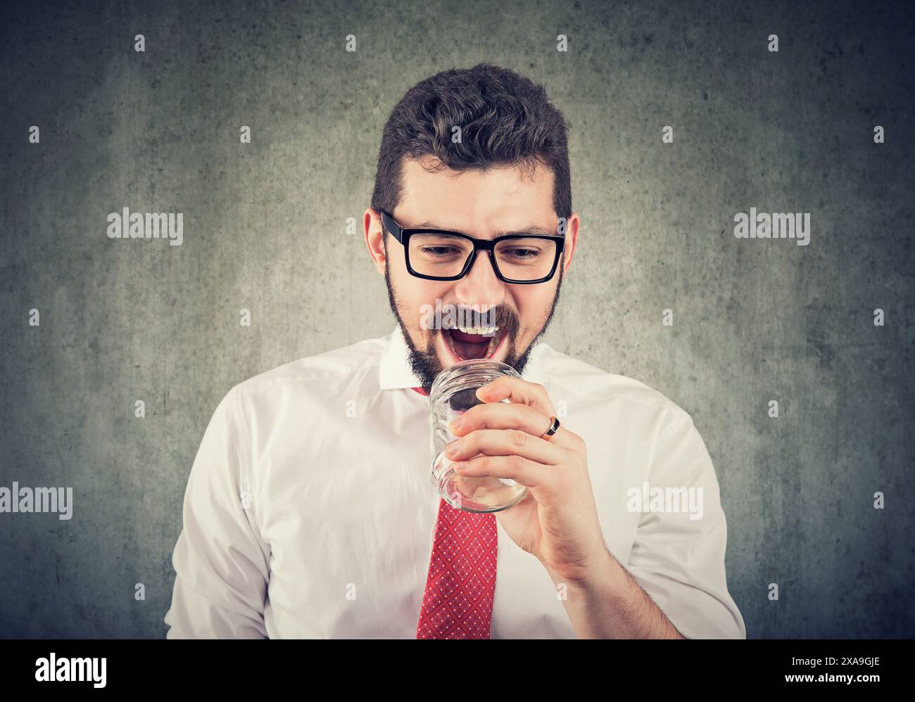 Portrait of a young business man shouting into an empty glass jar Stock ...