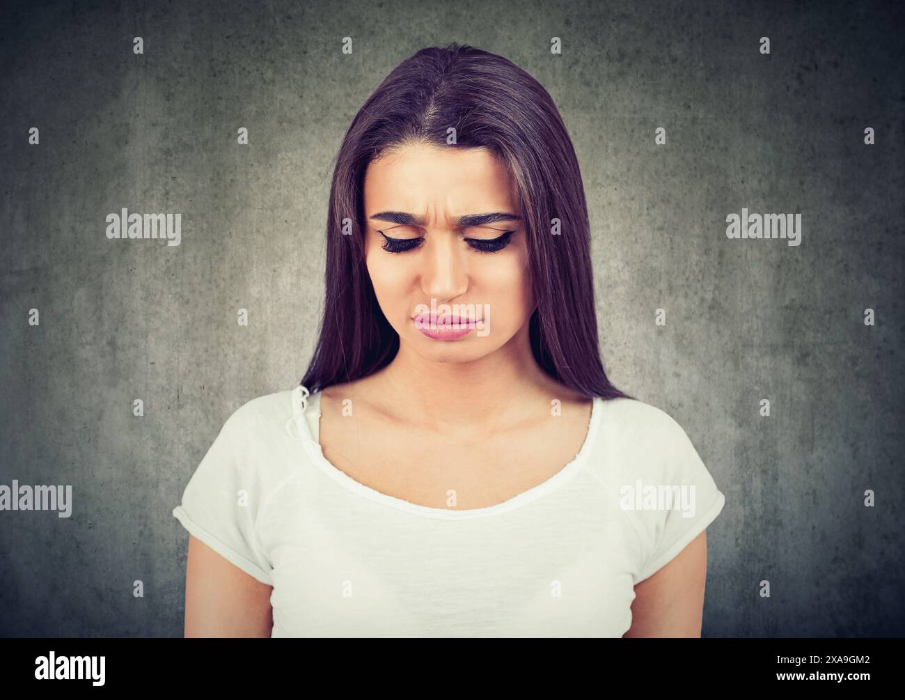 Portrait of a young sad woman looking worried and feeling depressed ...
