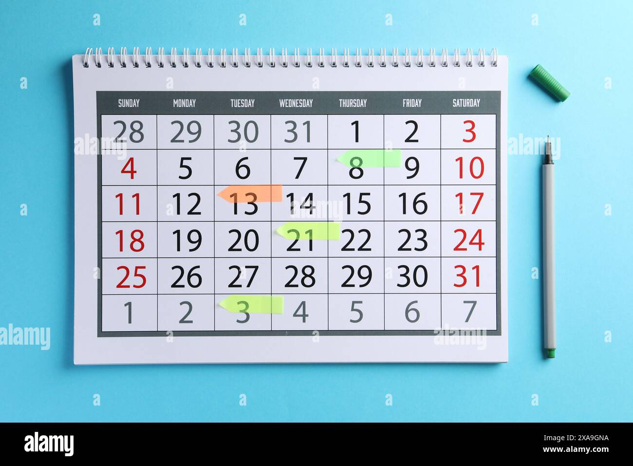 Timetable. Calendar with marked dates and pen on light blue background ...