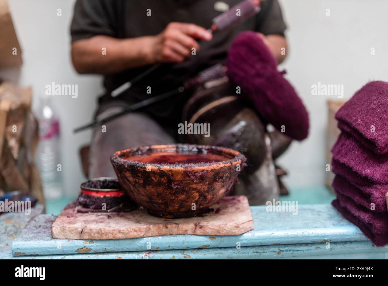 A Tunisian Chaouachis works with vermillion red dye in the making of ...