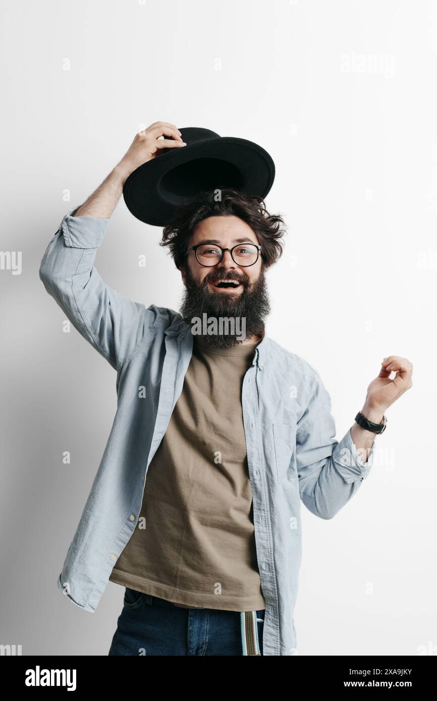 Joyful bearded man tipping his hat in a greeting gesture Stock Photo ...
