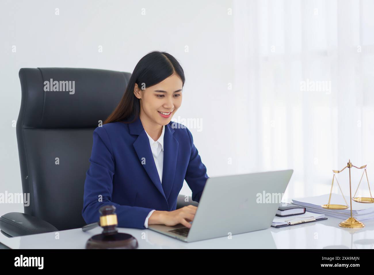 Lawyer woman typing business contract and law agreement on laptop with ...