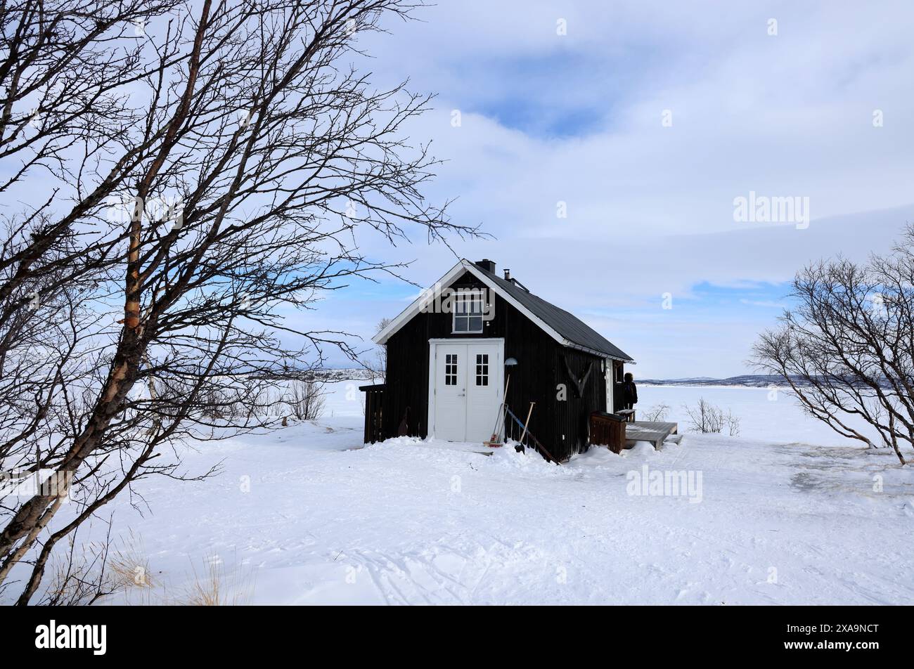 A tiny snow-covered house in a winter landscape Stock Photo - Alamy