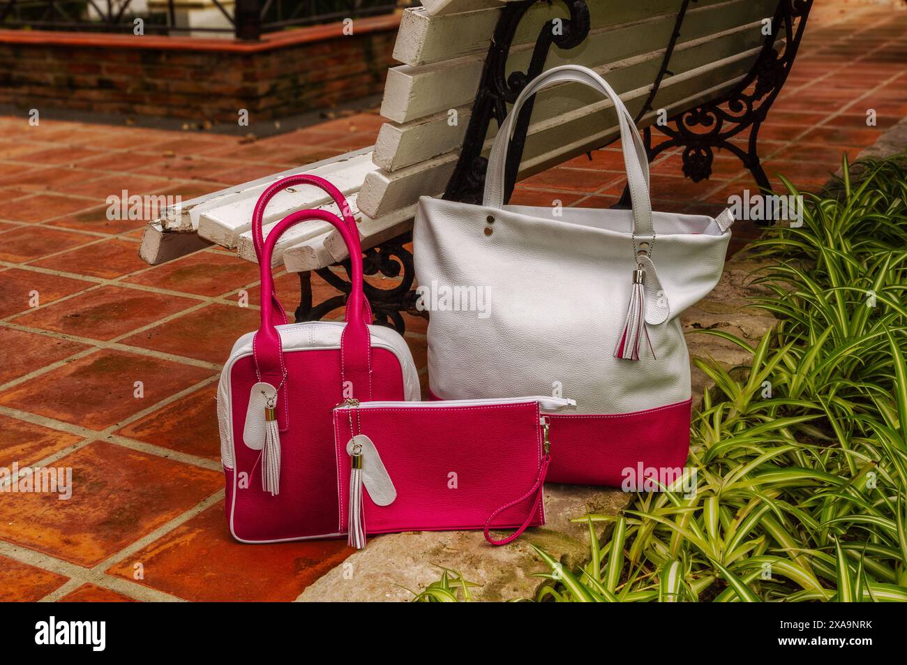 Three bags placed in front of a bench on the ground Stock Photo - Alamy