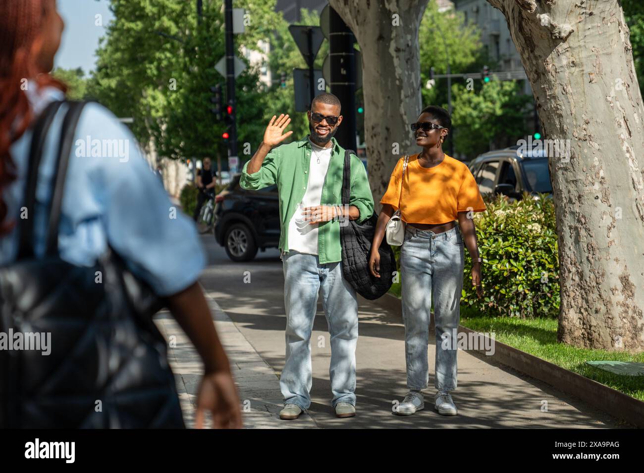 Happy black man waving hand to friend, greeting. Guy on date with girl ...
