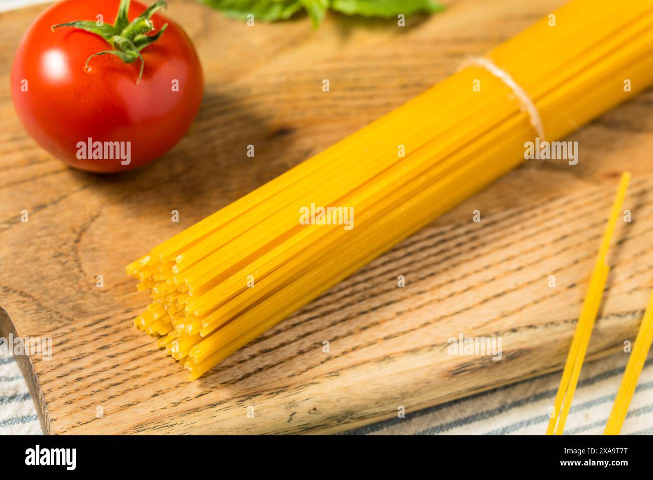 Dry Raw Yellow Italian Spaghetti in a Bundle Stock Photo - Alamy