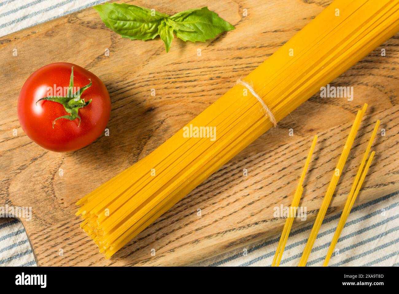 Dry Raw Yellow Italian Spaghetti in a Bundle Stock Photo - Alamy