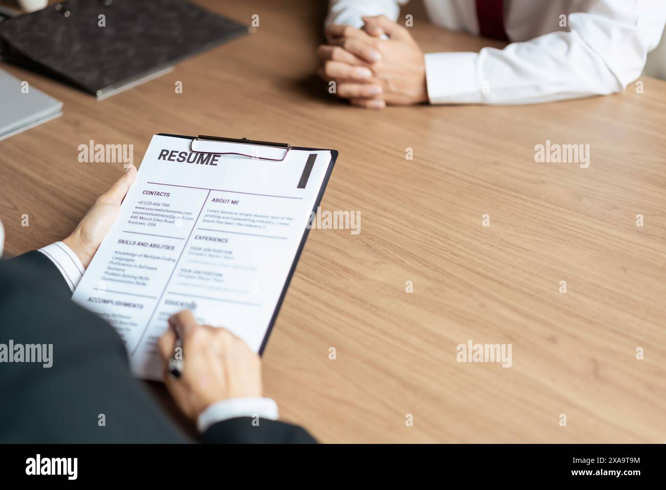 HR manager woman reading resume and asking questions with male ...