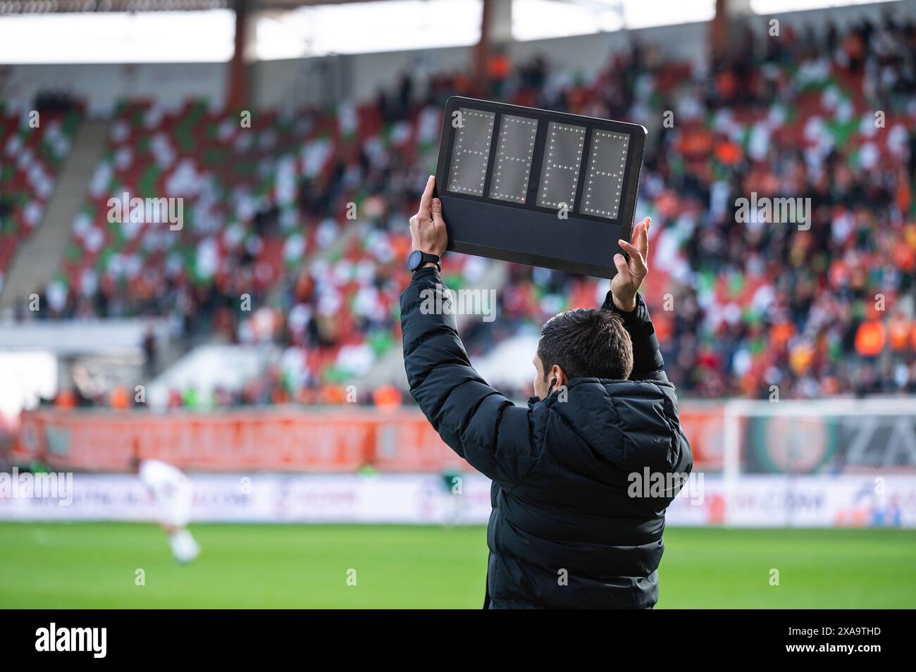 Technical referee shows added time during football match Stock Photo ...