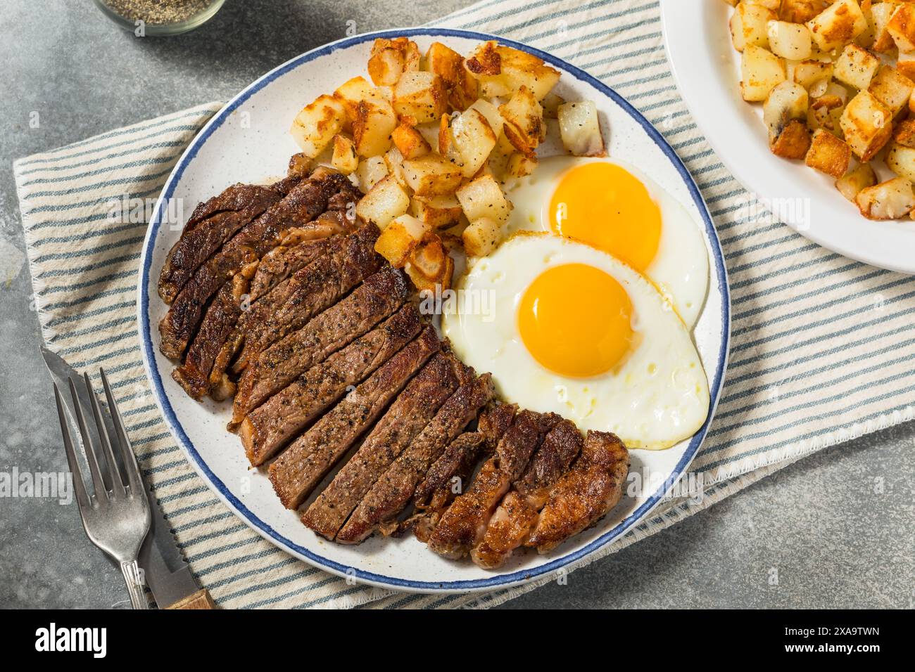 Healthy Breakfast Steak and Eggs with Hash Browns Stock Photo - Alamy
