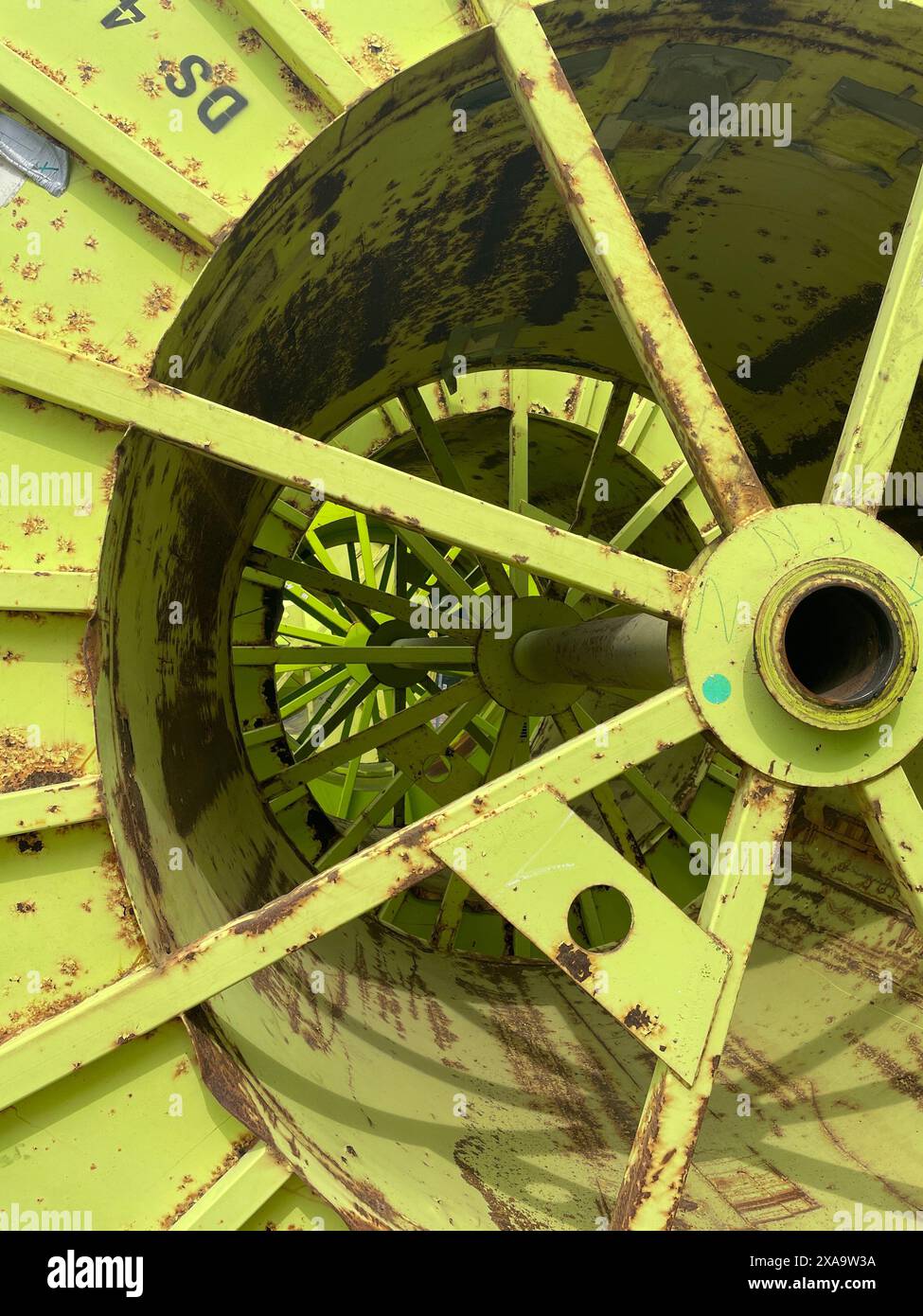 A Close-up of vintage industrial machinery wheel with yellow metal ...