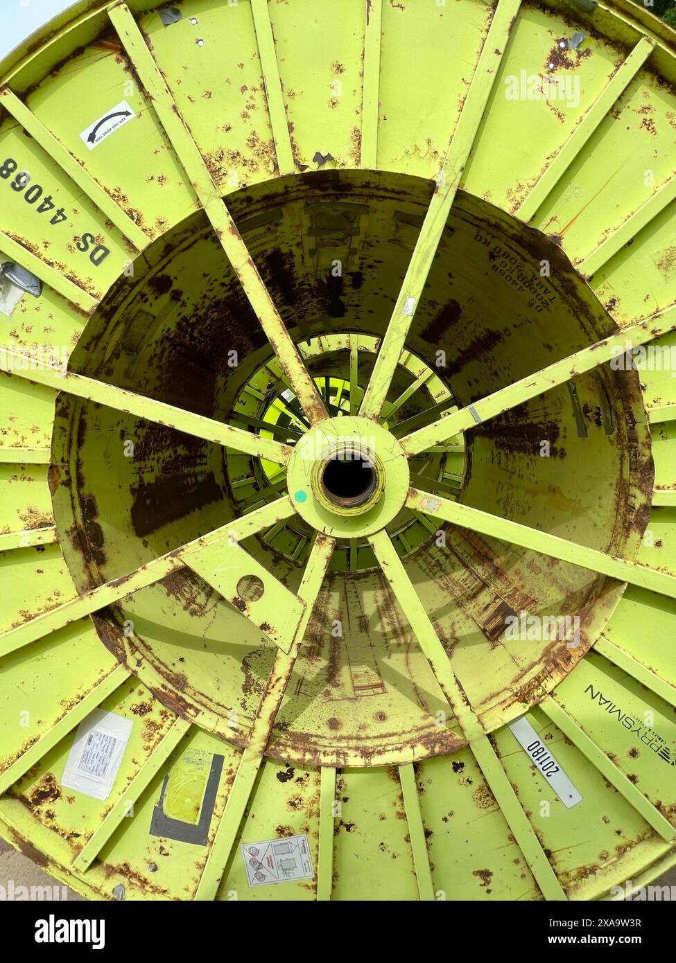 A Yellow metal wire wheel in parking lot Stock Photo - Alamy