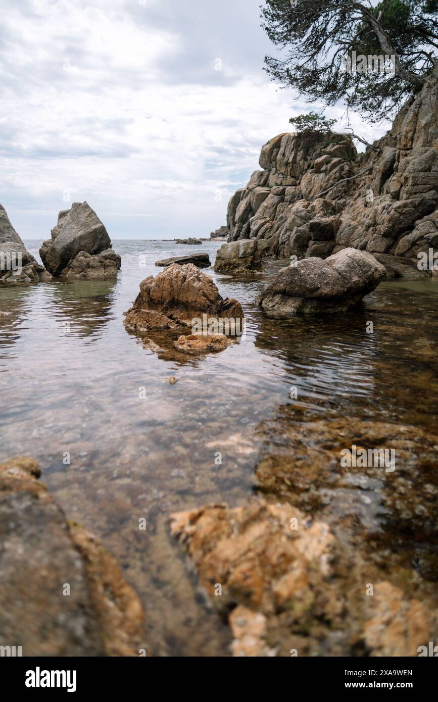 Rocky shore with rocks in the water Stock Photo - Alamy