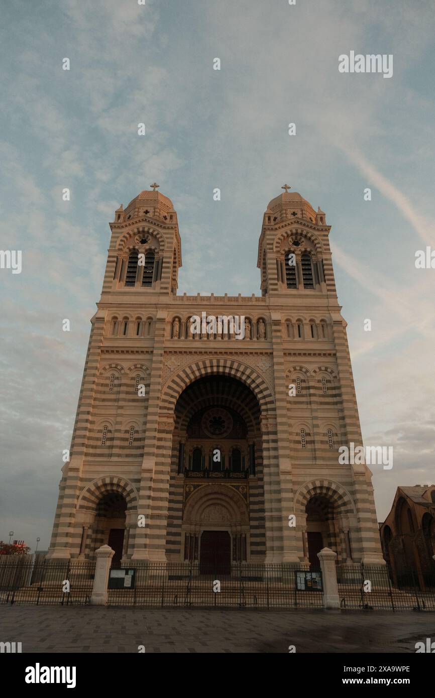An ancient stone church featuring steeple and twin towers Stock Photo ...