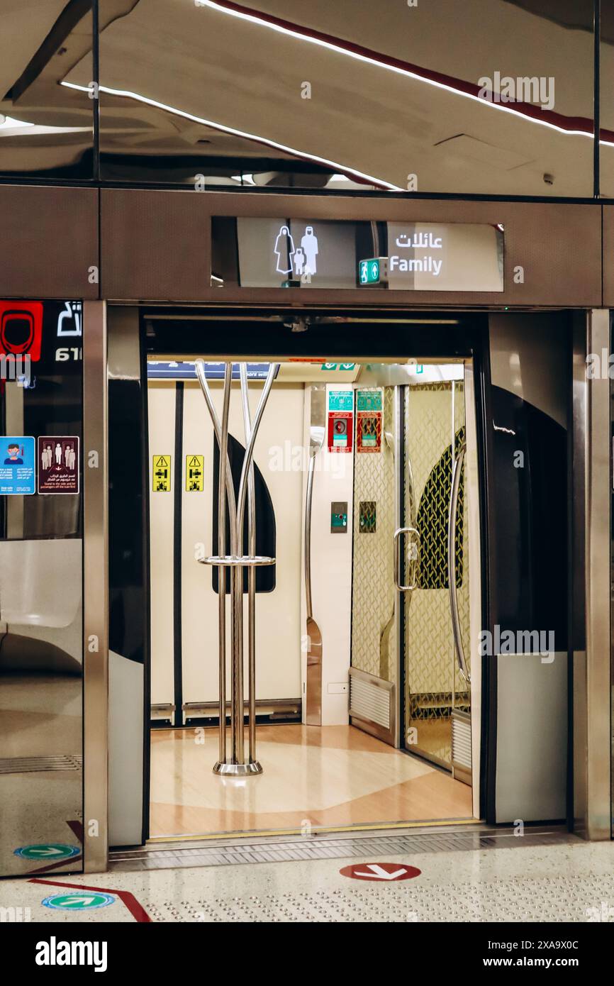 Doha, Qatar - 1 May 2024: Train at a metro station in Doha, open door ...