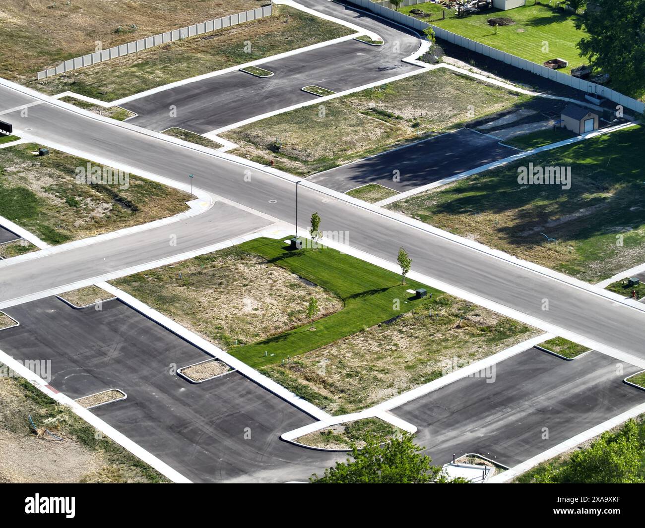 Aerial view of urban street with bus stop and park in the distance ...