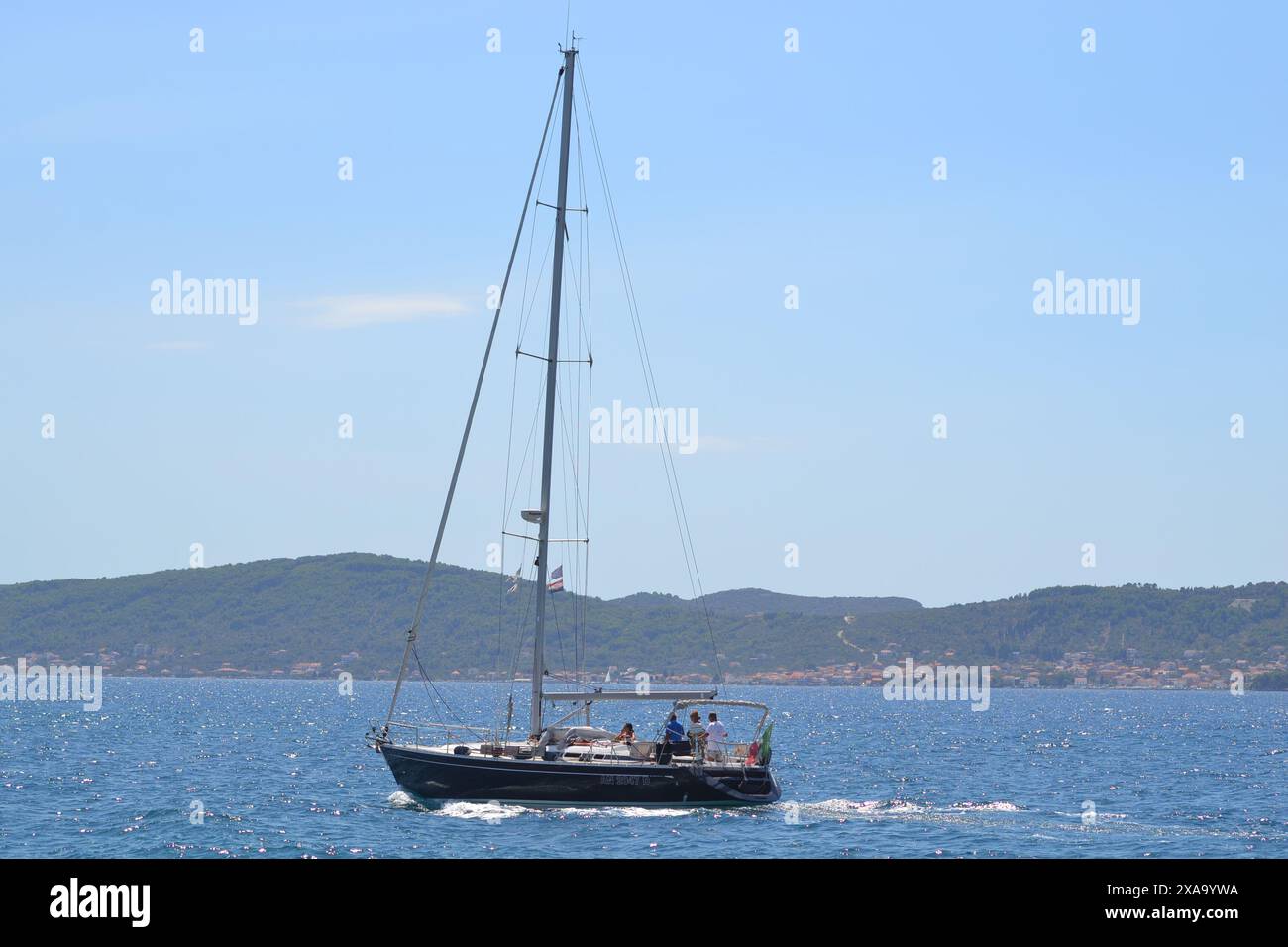 boat sailing in the vast ocean with passengers on board Stock Photo - Alamy