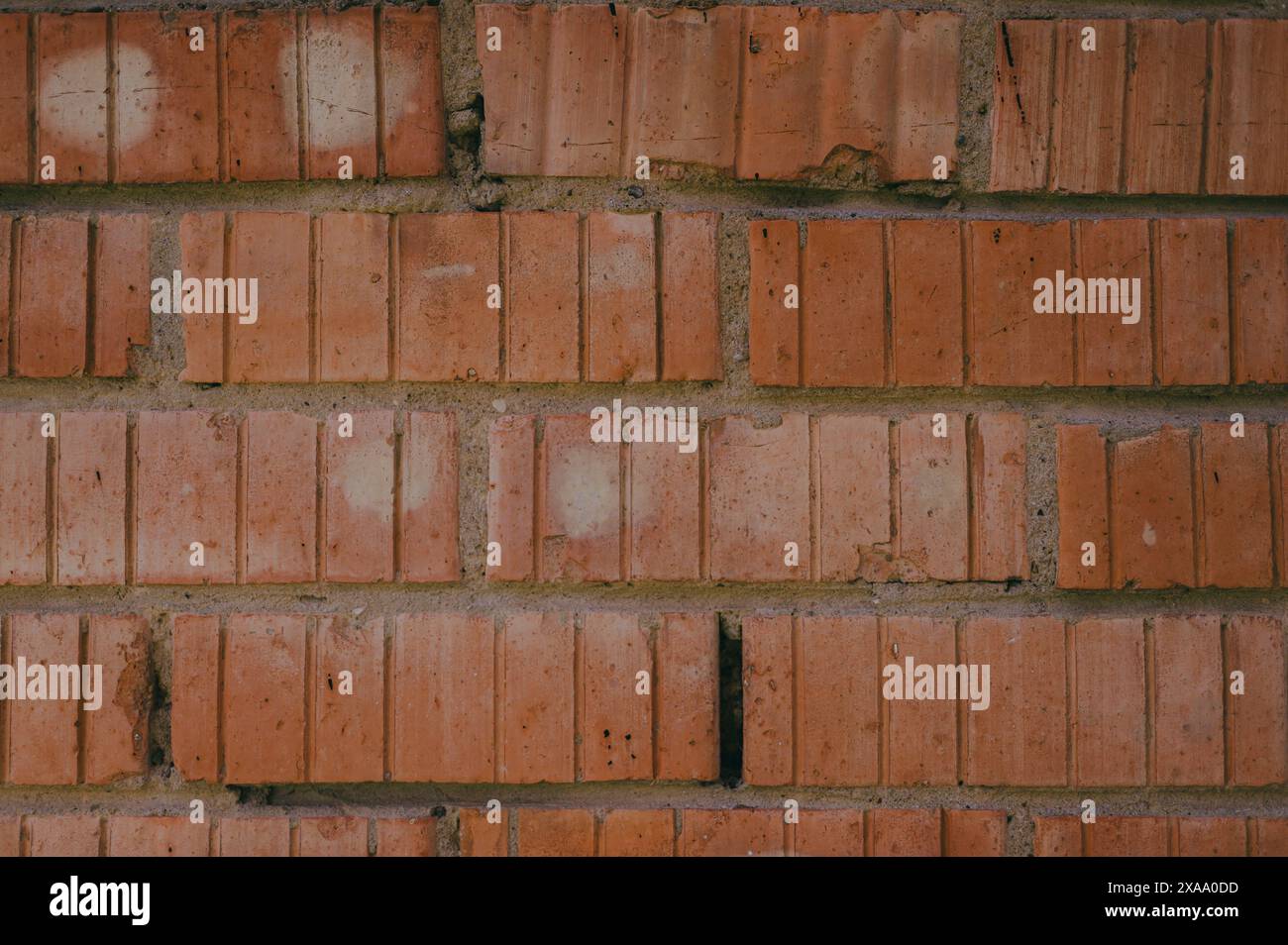 A weathered red brick wall with faded paint Stock Photo - Alamy