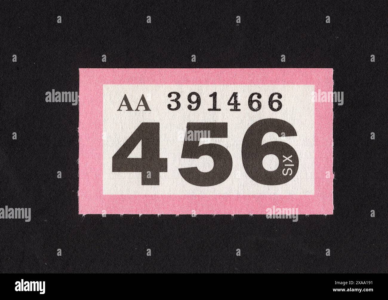 A vintage raffle ticket isolated on a black background Stock Photo - Alamy