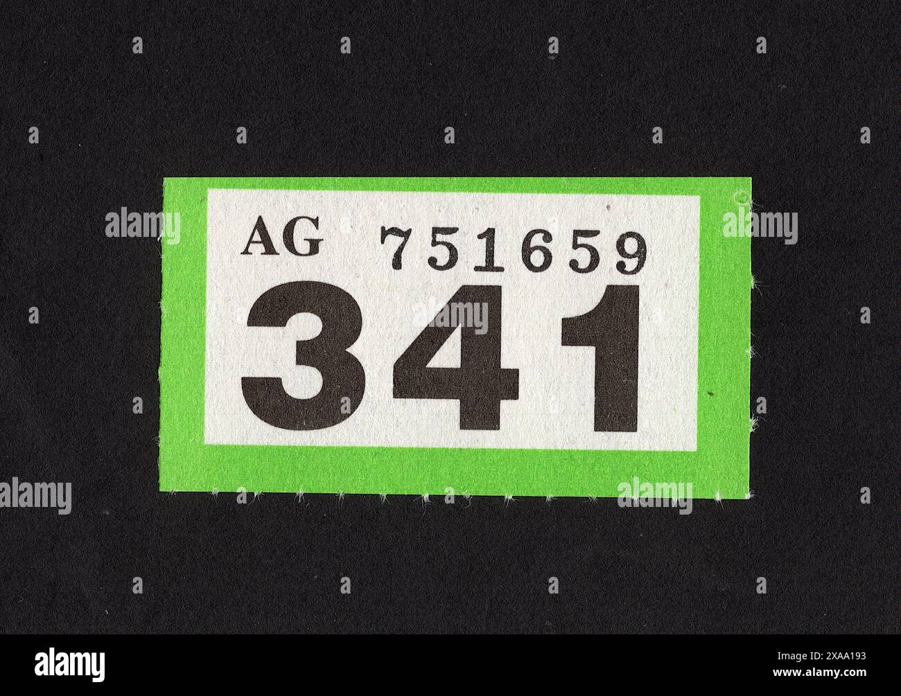 A vintage raffle ticket isolated on a black background Stock Photo - Alamy