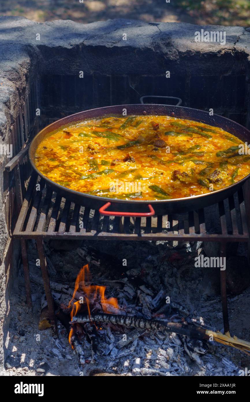 close-up of a typical Spanish paella cooked over a wood fire in the ...
