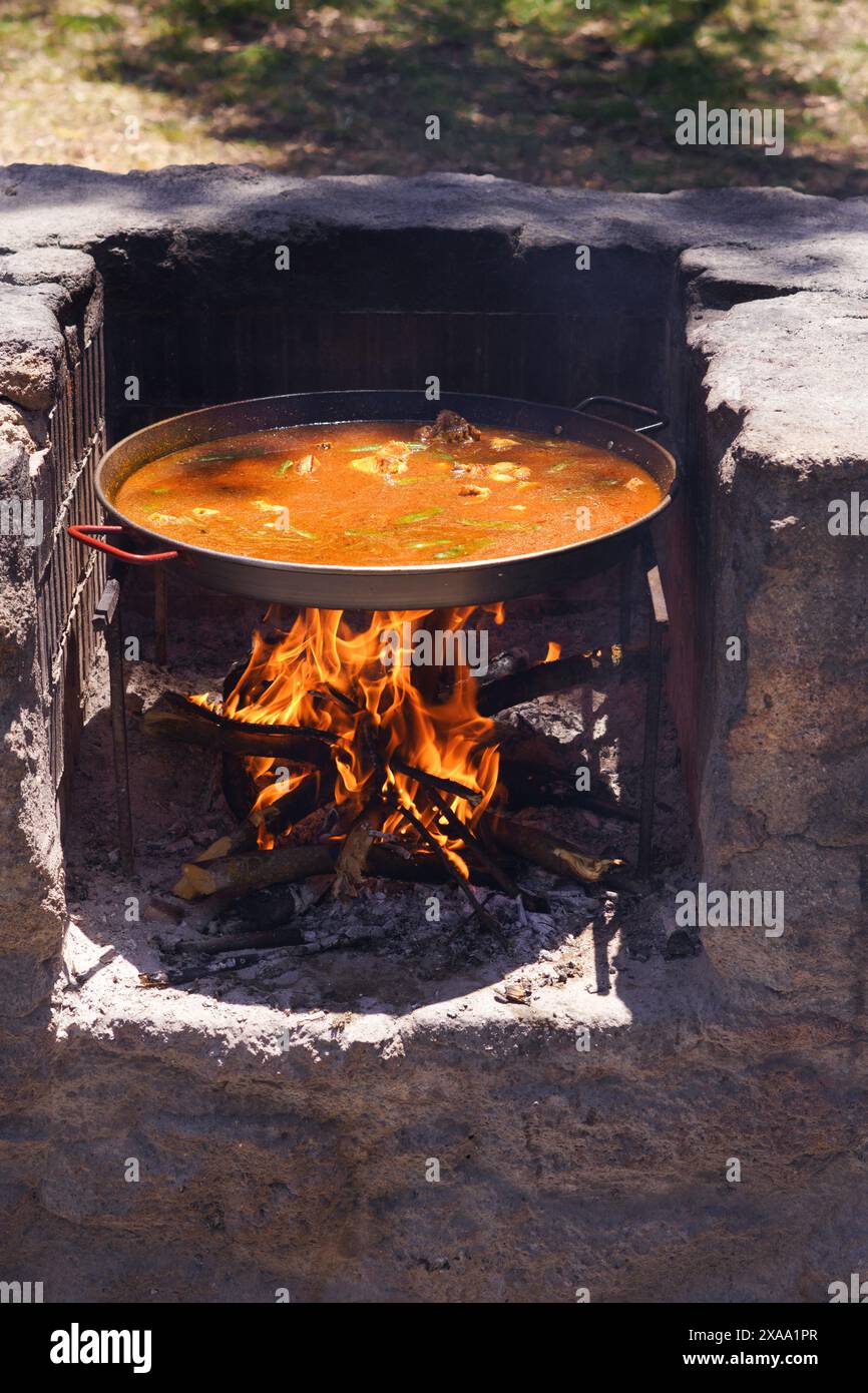 close-up of a paella pan with a typical Spanish paella cooking on the ...