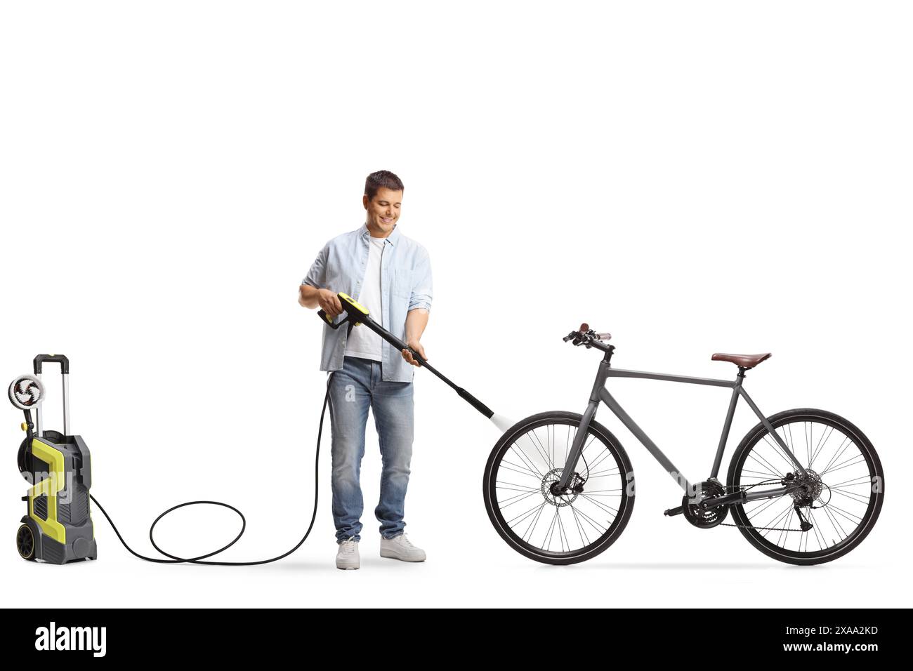 Man washing a bicycle with a high pressure washer machine isolated on ...