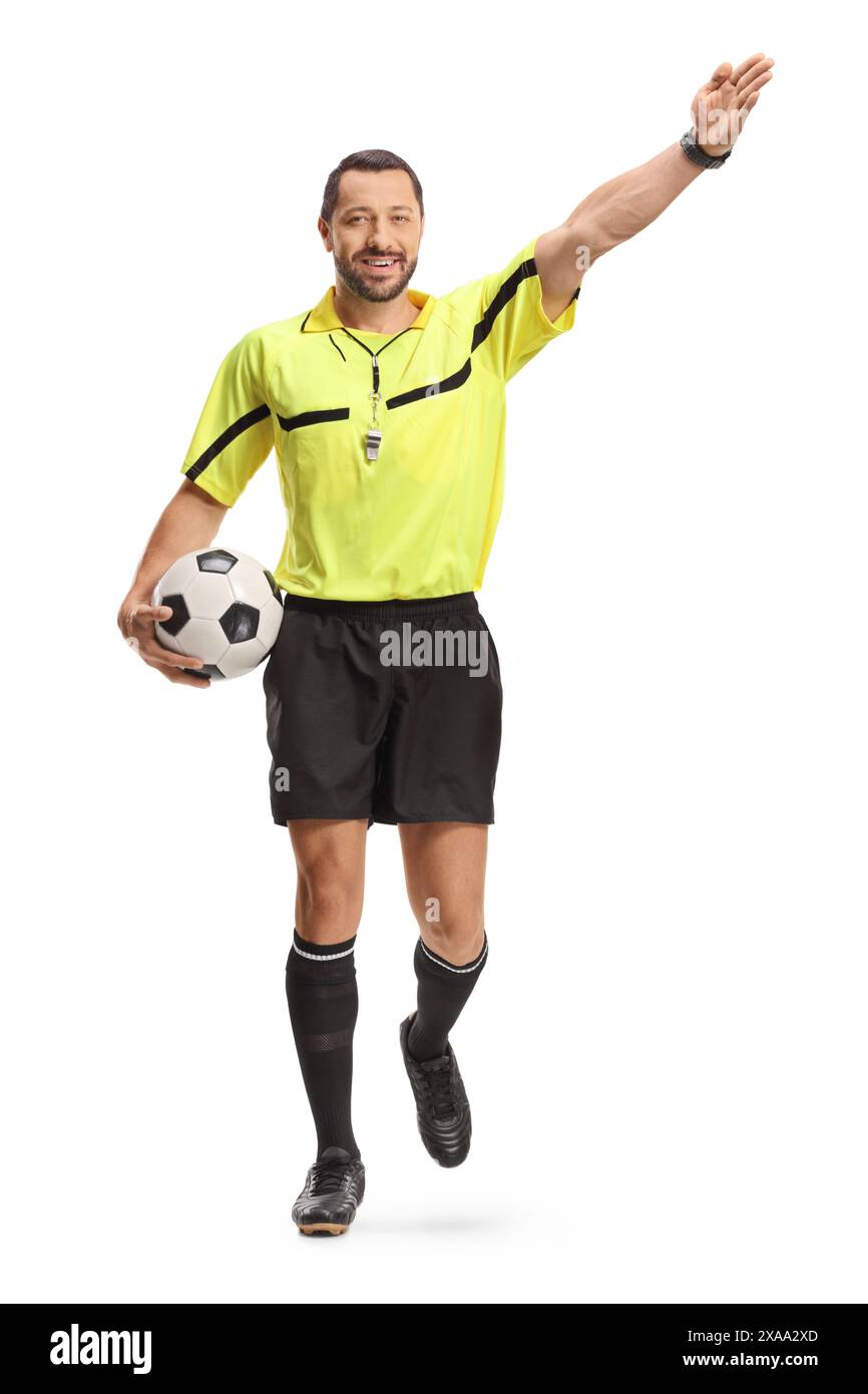 Portrait of a football referee carrying a ball and pointing with hand ...
