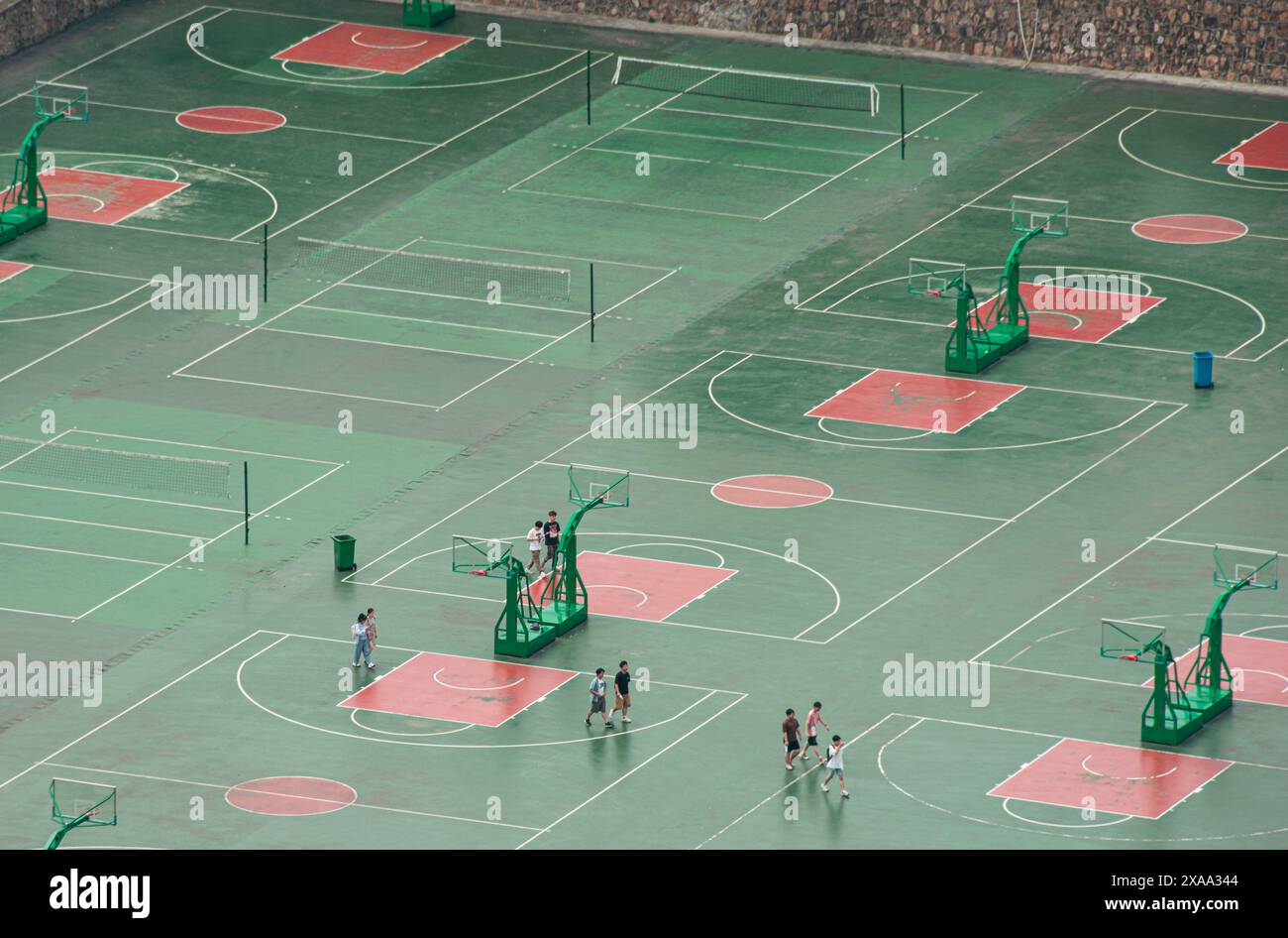 The open basketball court of a university in Wuhan. A few students ...