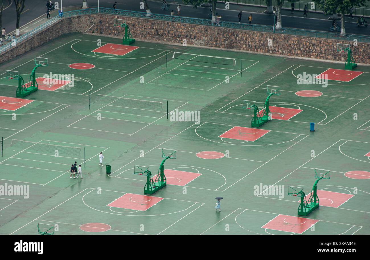 The open basketball court of a university in Wuhan. A few students ...