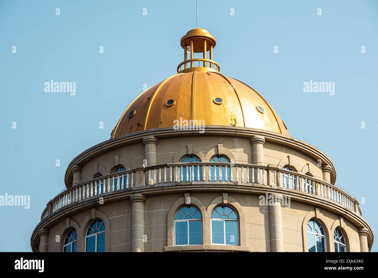 Golden dome atop adjacent white balconyed building Stock Photo - Alamy