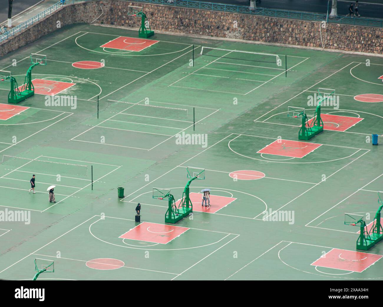The open basketball court of a university in Wuhan. A few students ...