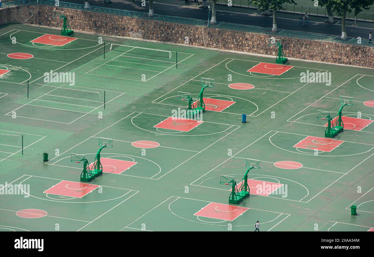 The open basketball court of a university in Wuhan. A few students ...