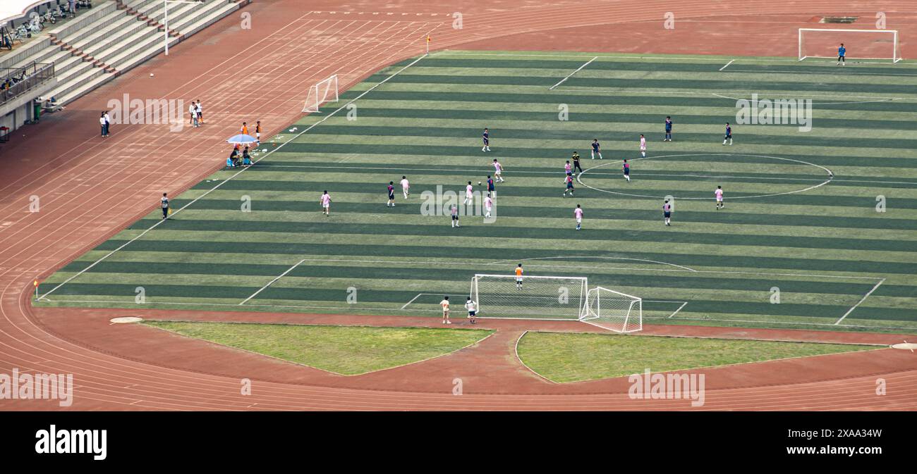 On the football field of a university in Wuhan, two student football ...