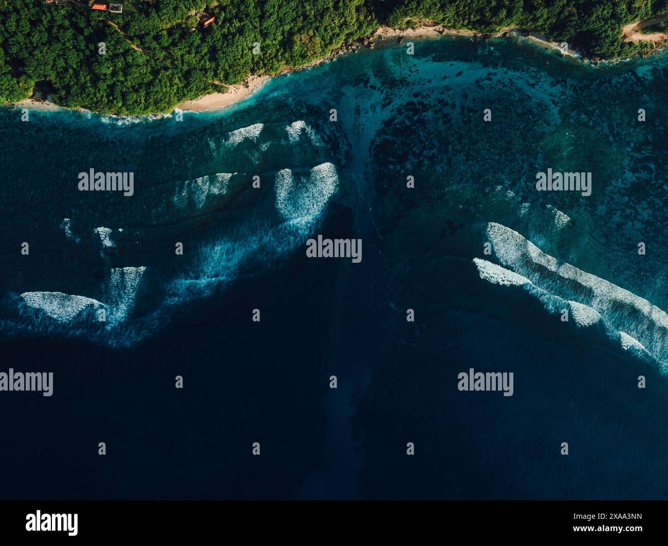 Aerial view of scenic coastline with ocean waves and current canal in ...