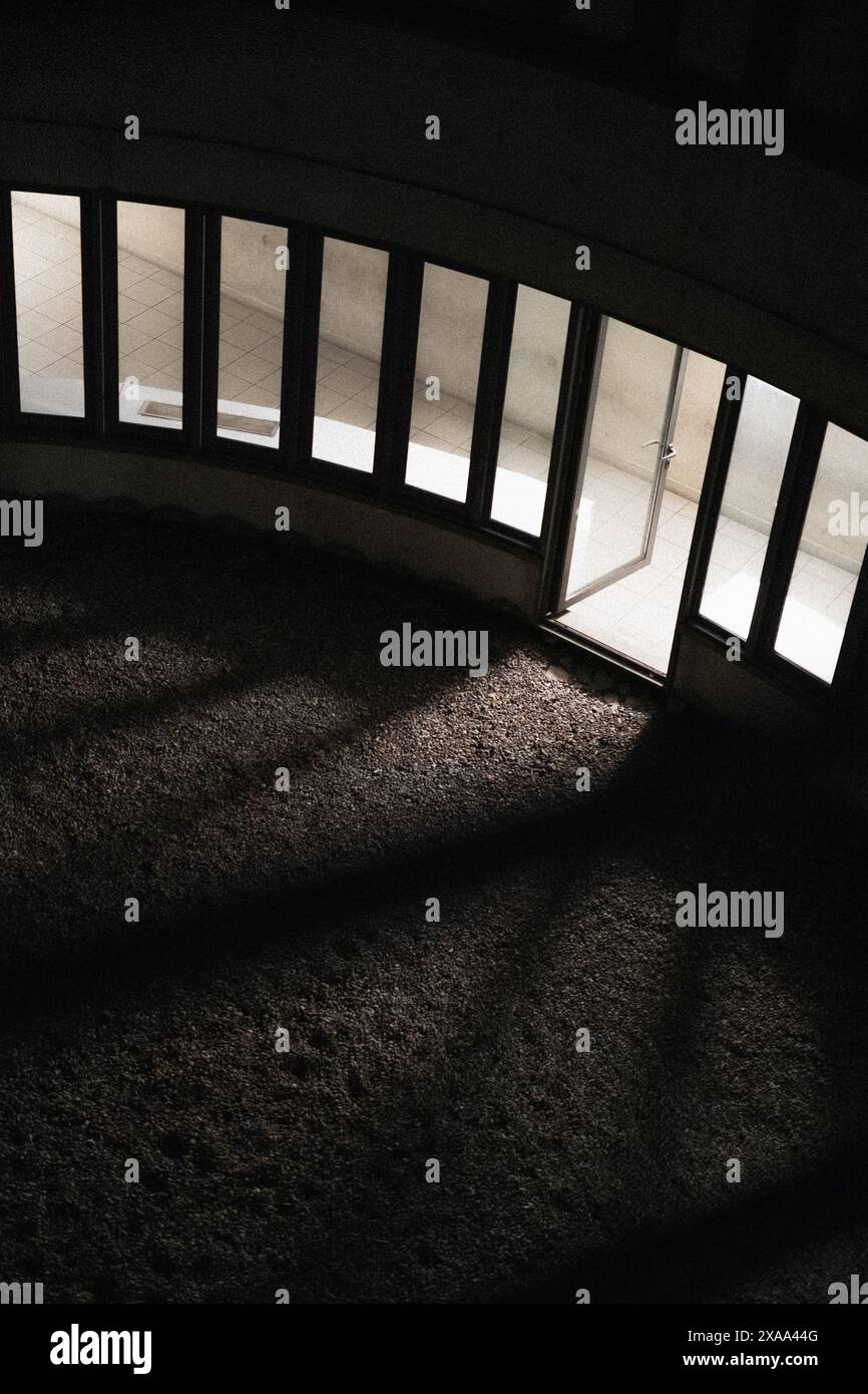 A high angle view of dimly lit corridor with large windows Stock Photo ...