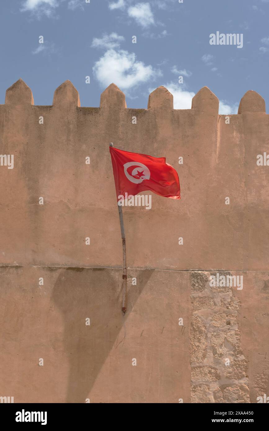 The Tunisian national flag flying from inside the ancient city walls of ...