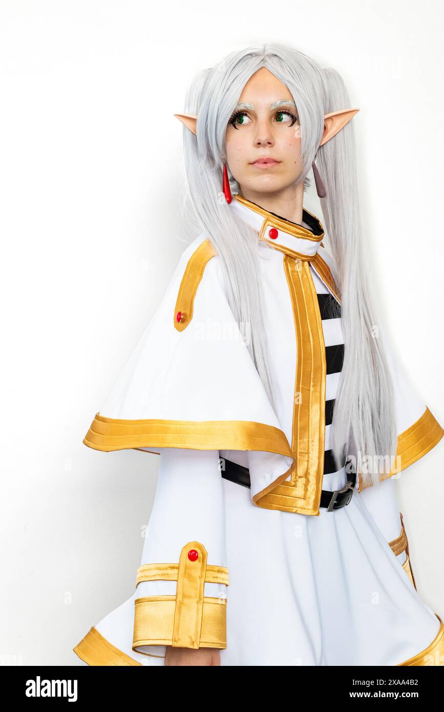 A female cosplayer dressed as an elf character with white hair on a ...
