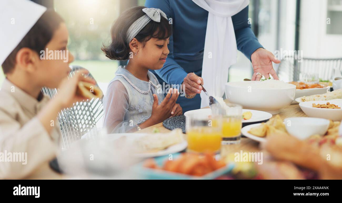 Muslim, children and eating food with family for eid mubarak in living ...