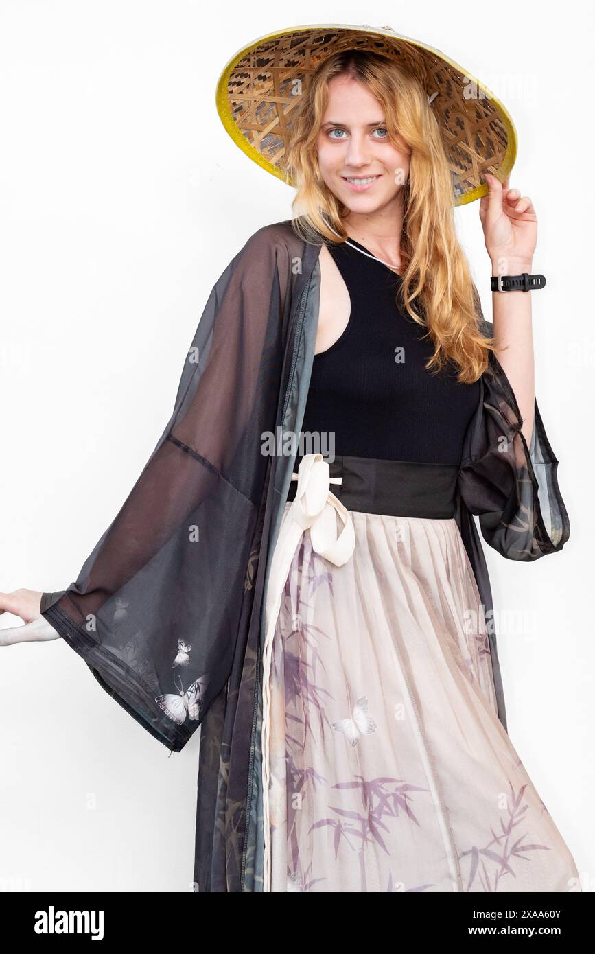 A female cosplayer in a patterned dress with seethrough sleeves wearing ...